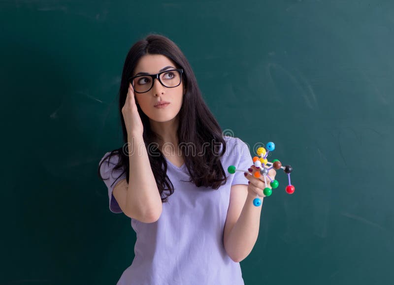 Young Female Teacher Student in Front of Green Board Stock Photo ...