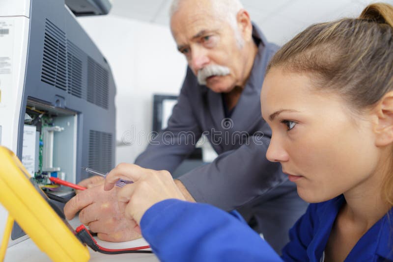 Young Female Technician Using Multimeter on Appliance Stock Image ...