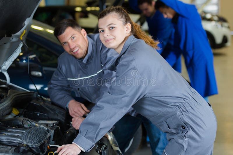 Young Female Trainee Fixing Car Engine in Garage Stock Image - Image of ...