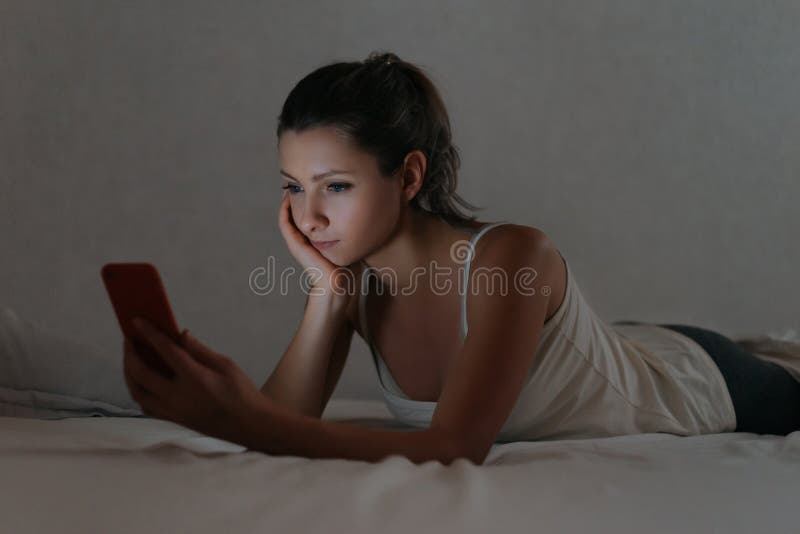 Amazed Face of Young Woman Staring Up at Her Smartphone Late at Night ...