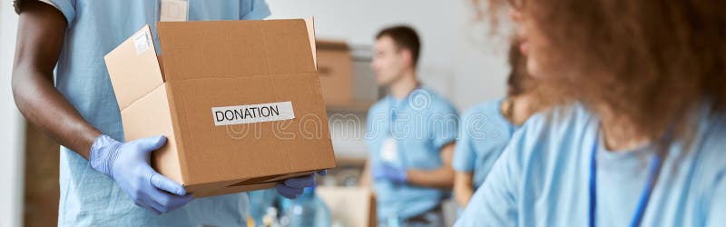 Young Female Volunteer in Blue Uniform Making Notes while Working on ...