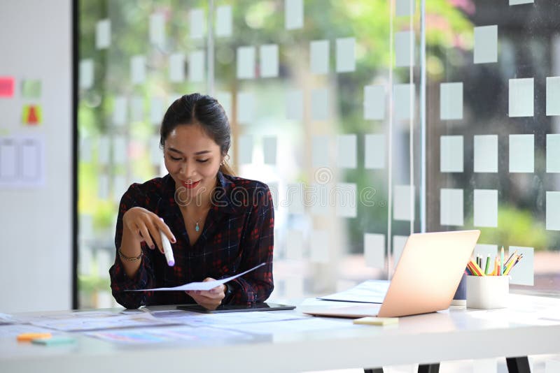 Female Website Developer Reviewing Sketched Wireframe Layout Design for ...