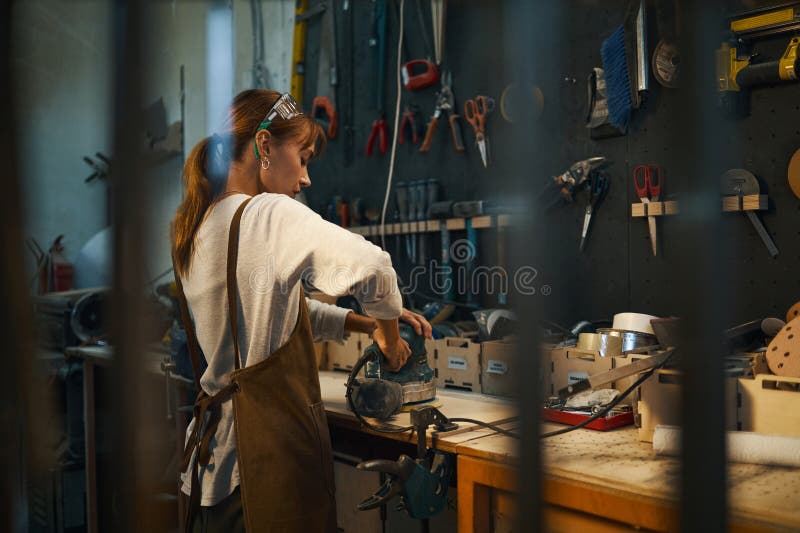Female Worker Using Polishing Machine in Workshop Stock Photo - Image ...