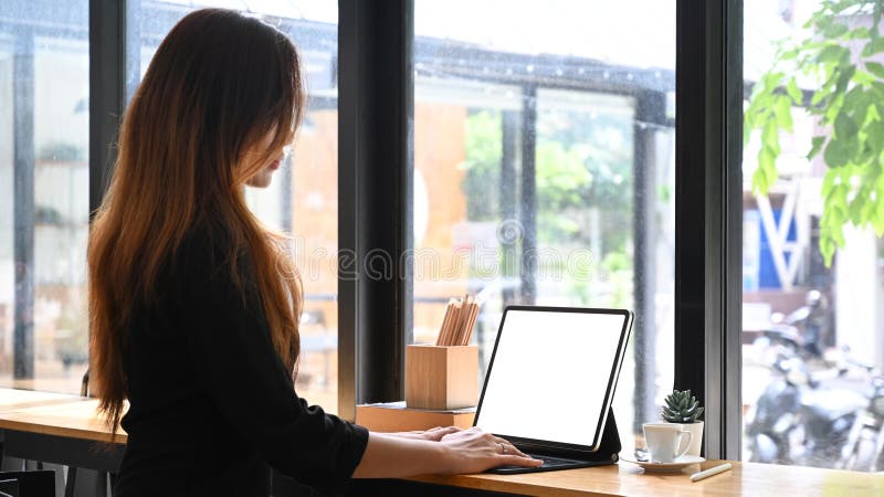 Young Female Working with Computer Tablet in Cafe. Stock Photo - Image ...