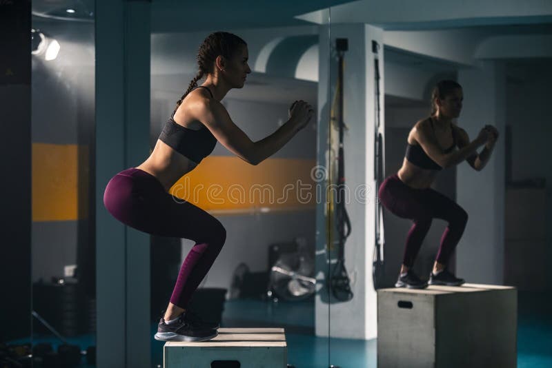 A Young Female Doing a Box Jump in the Gym Stock Photo - Image of power ...