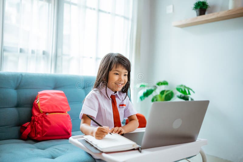 First Grade School Student with Uniform during Online Class Study with ...
