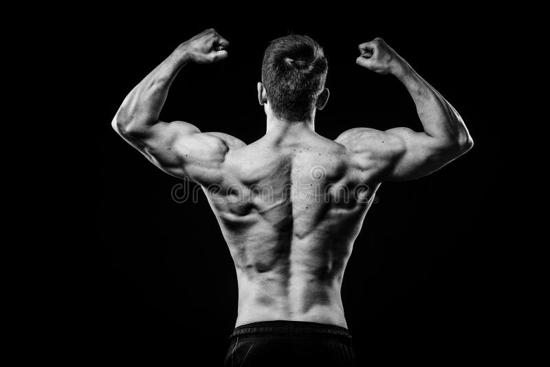 Young and Fit Bodybuilder Athlete Demonstrates Biceps Back View on ...