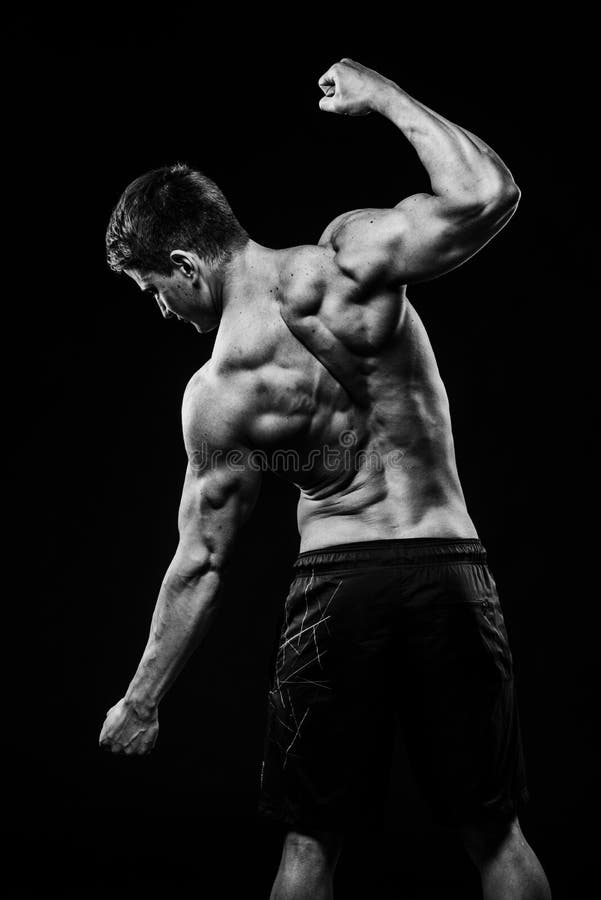 Young and Fit Bodybuilder Athlete Demonstrates Biceps Back View ...