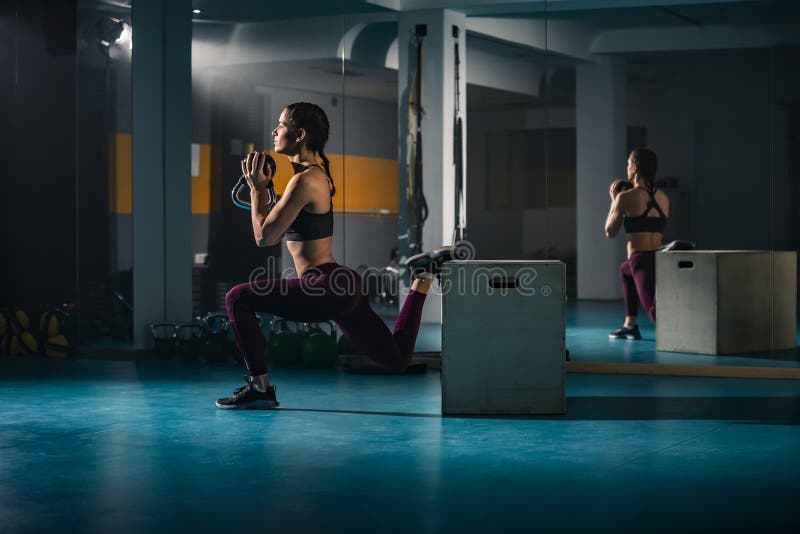 A Young Fit Woman Doing Split Squats Exercise in Gym Stock Image ...