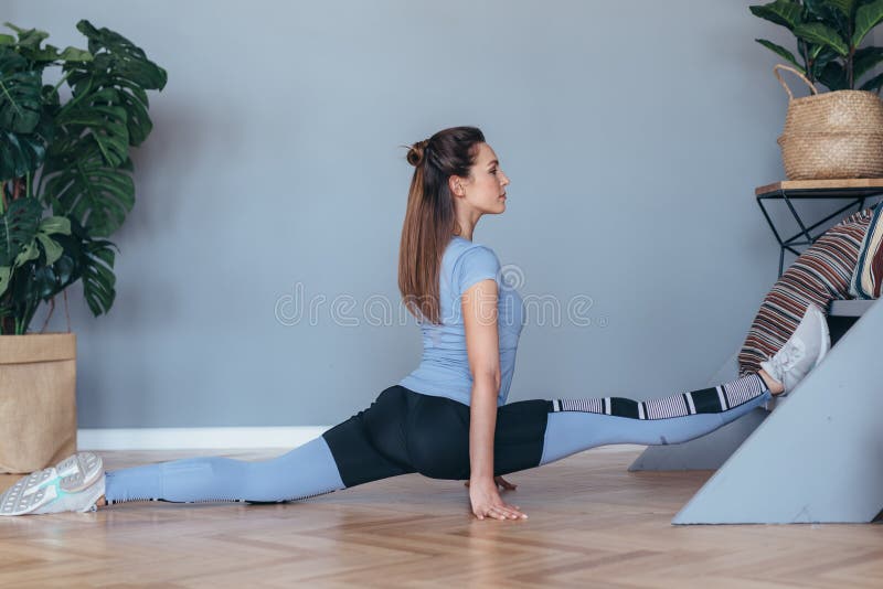 Young Fit Woman Doing the Splits Working Out at Home. Stock Photo ...