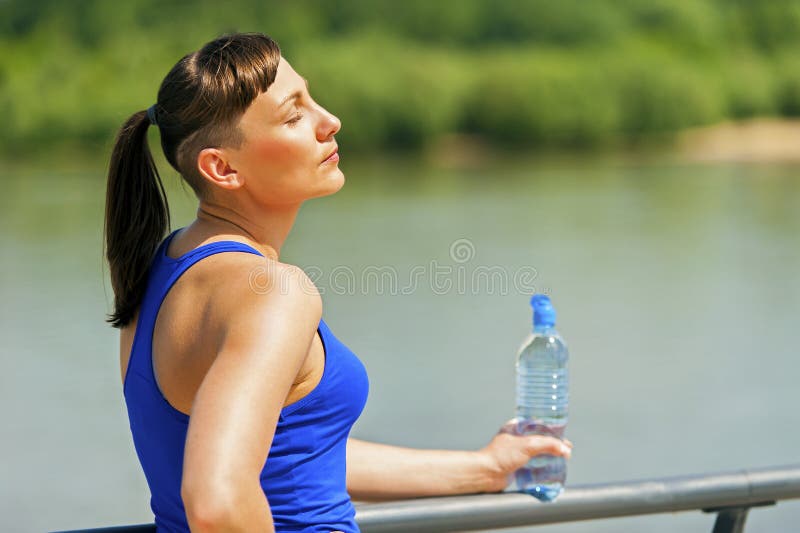 Young Fit Woman Resting after Jogging by the River in City. Stock Photo ...