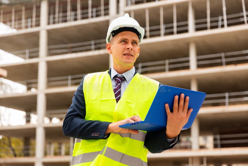 Young Focused Engineer Controlling the Progress of Work on a Laptop ...