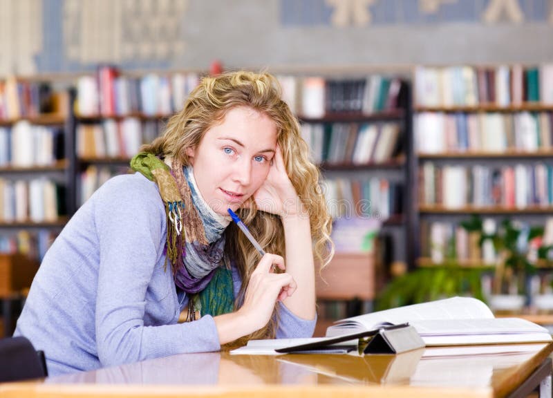 Young Focused Student Using a Tablet Computer in a Library Stock Image ...