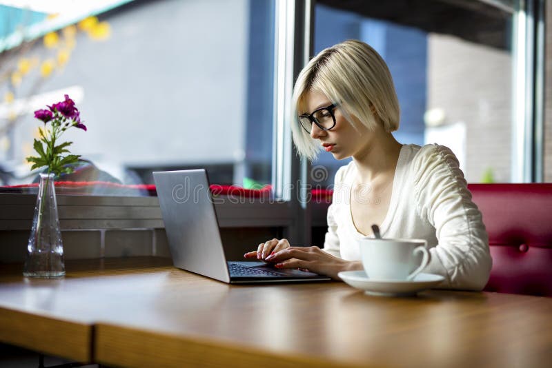 Young Focused Woman Working on Laptop in Cafe Stock Photo - Image of ...