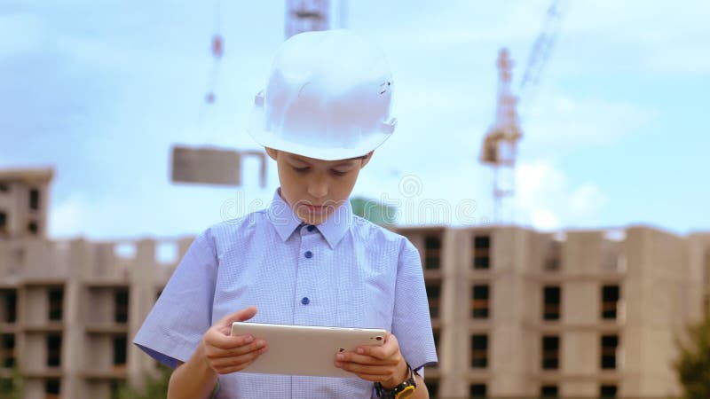Young Foreman: Boy on Construction Site with Tablet, Overseeing ...