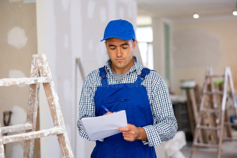 Young Foreman Checks the Completed Construction Work and Signs the ...