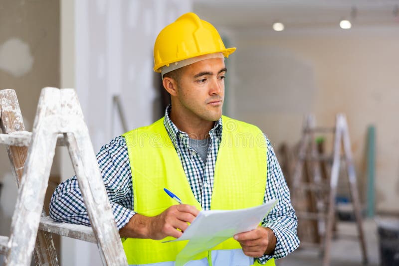 Young Foreman Checks the Completed Construction Work and Signs the Documents Stock Image - Image ...