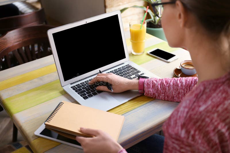 Young Freelancer with Laptop Working and Notebook in Cafe Stock Photo ...