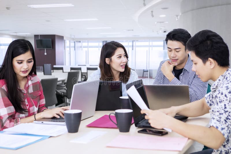 Young Freelancer Team Works with Laptops in Office Stock Photo - Image ...