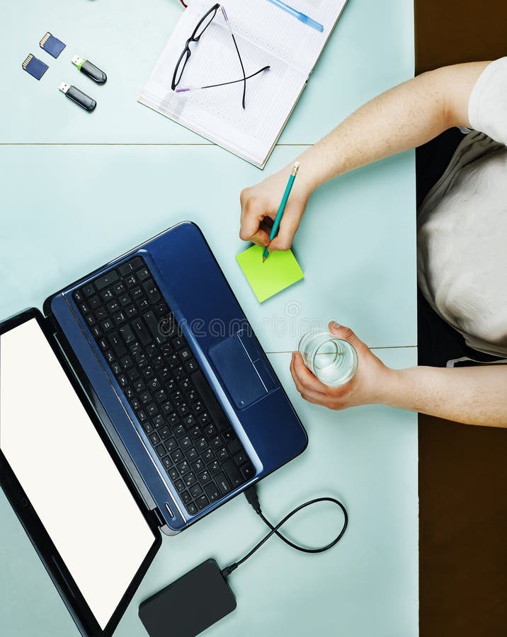 Young Freelancer Working at Home at a Table Using a Laptop Stock Photo ...