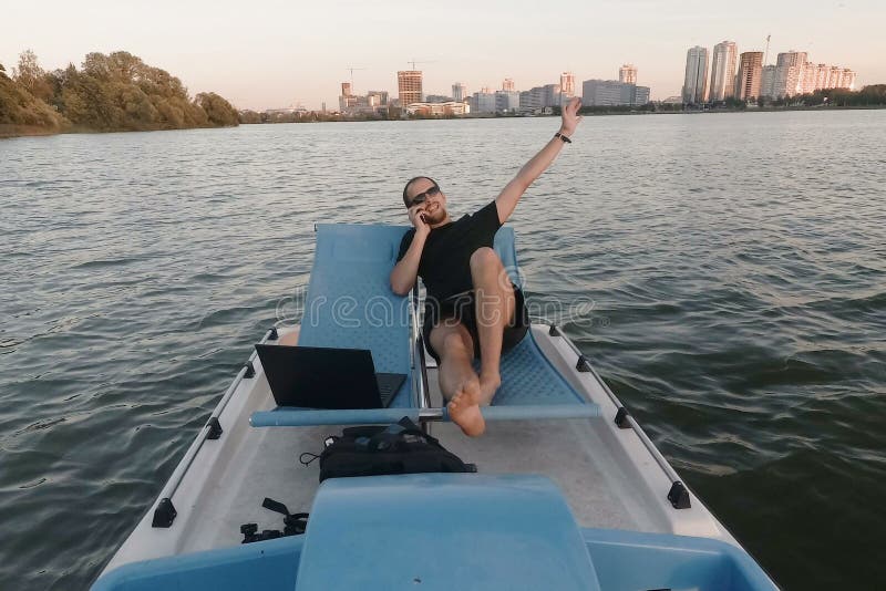 Young Freelancer Works on the Computer on a Boat. Remote Business ...