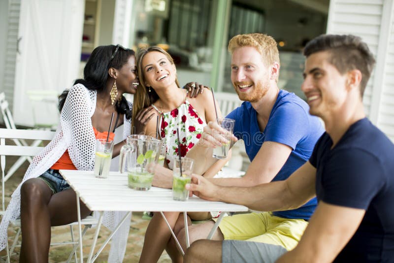Young friends at cafe stock image. Image of female, ethnic - 64376685