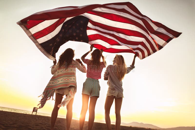 Friends Carrying American Flag on the Beach Stock Image - Image of ...