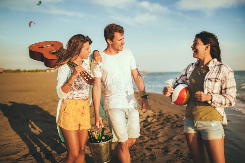 Friends Enjoying a Walk on the Beach on a Sunny Day and Having Fun ...