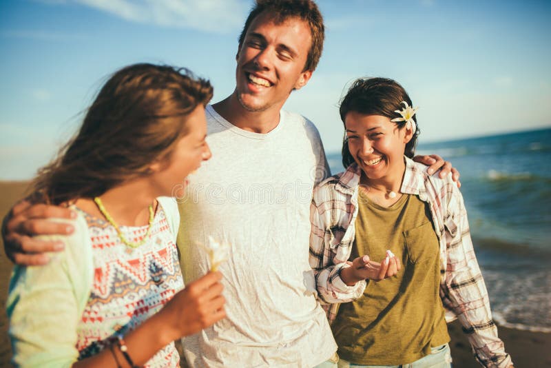 Friends Enjoying a Walk on the Beach on a Sunny Day and Having Fun ...