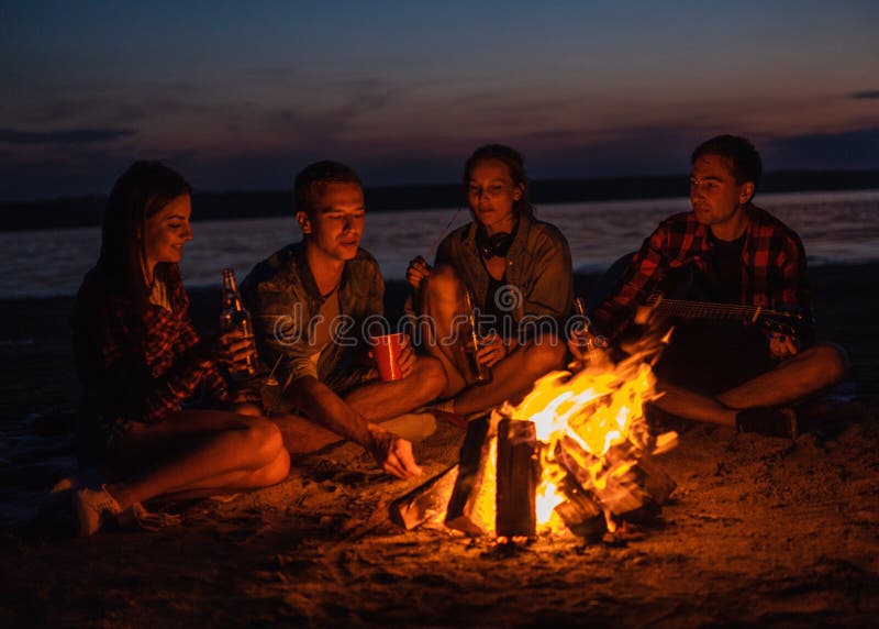 Young Friends Have Picnic with Bonfire on the Beach Stock Photo - Image ...