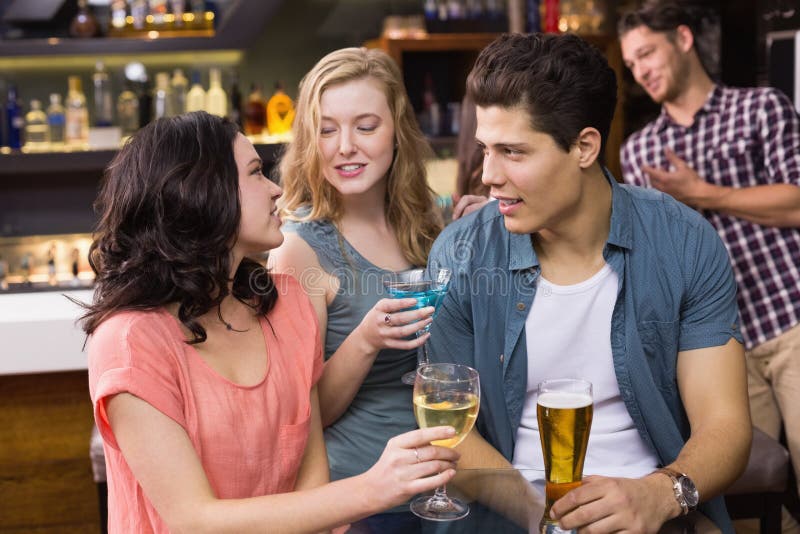 Young Friends Having a Drink Together Stock Photo - Image of friendship ...