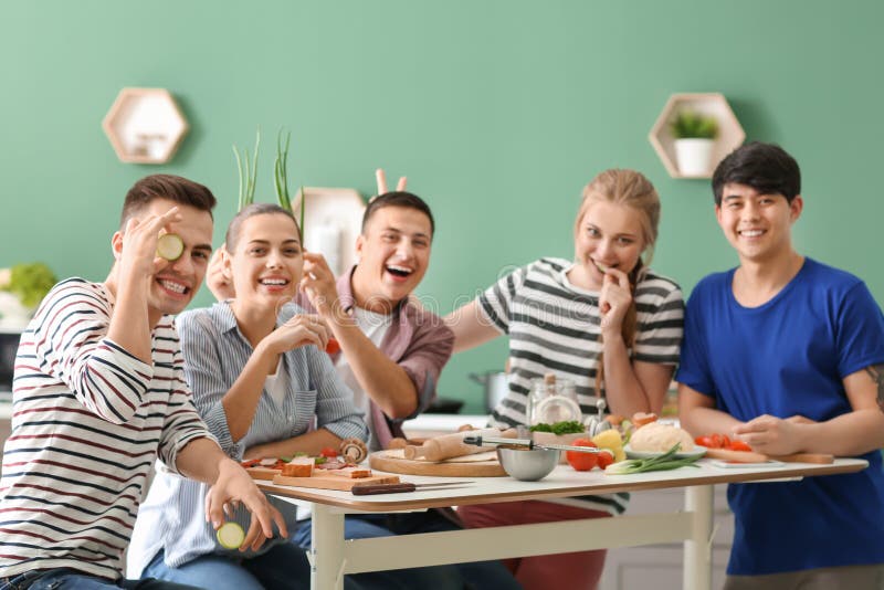 Young Friends Having Fun while Cooking in Kitchen Stock Photo - Image ...