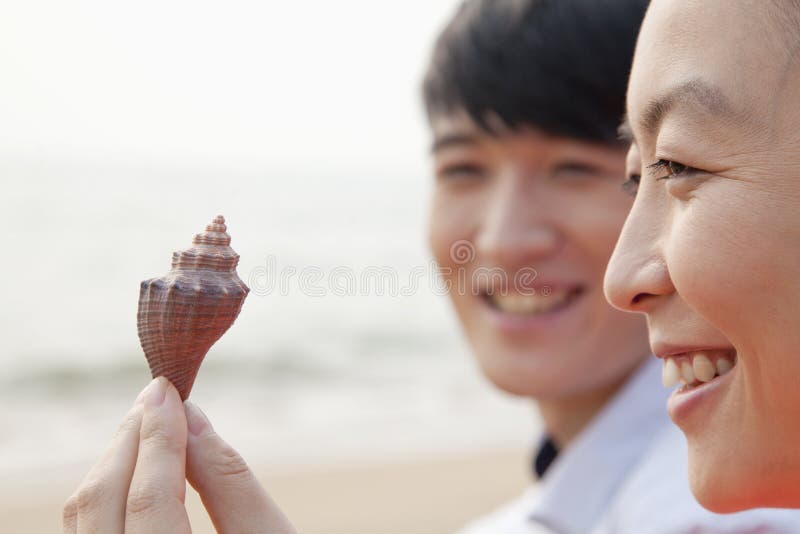 Young Friends Looking at Seashell Stock Image - Image of beauty ...