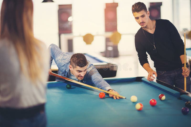 Young Friends Playing Billiard Stock Photo - Image of playful, leaning ...