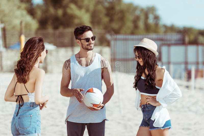 Young Friends Playing Volleyball on Sandy Beach Stock Image - Image of ...
