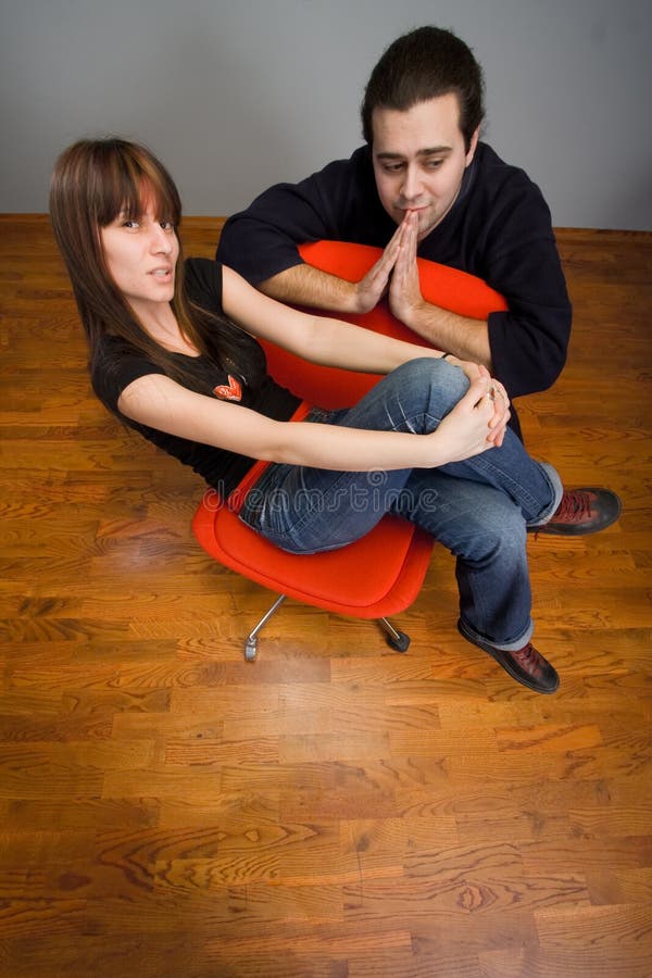 Young friends on red chair stock image. Image of contemporary - 5204261