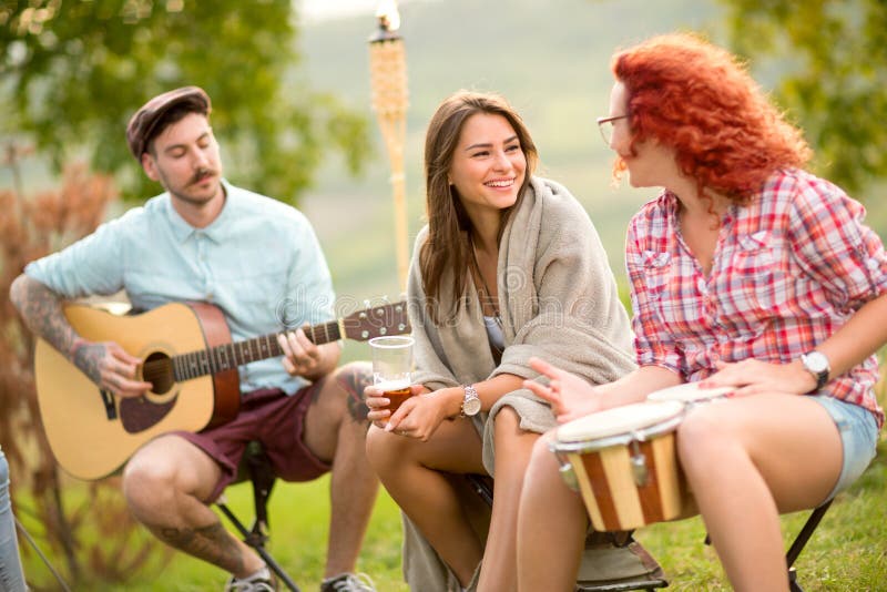 Young Friends Talk and Playing Instruments Stock Image - Image of ...