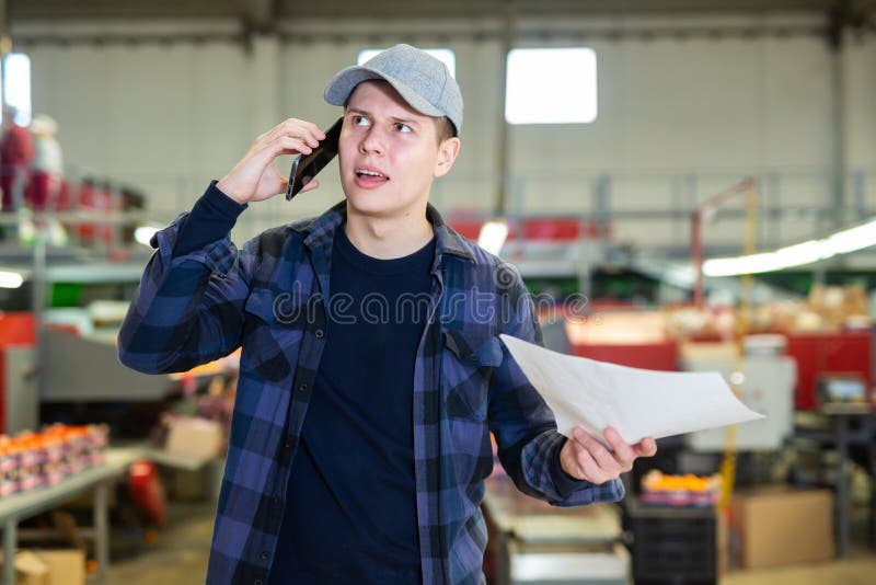 Young Fruit Factory Foreman with Papers Talking on Phone Stock Photo ...