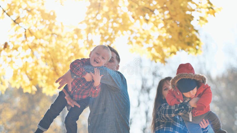 A Young, Fun Family Playing with Their Children in the Park in the Fall ...