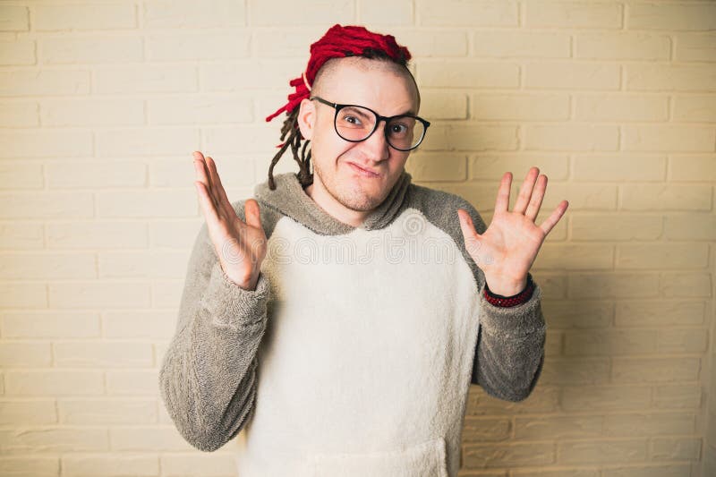 A Young Funny Hipster with Glasses and Red Dreadlocks Stock Photo ...