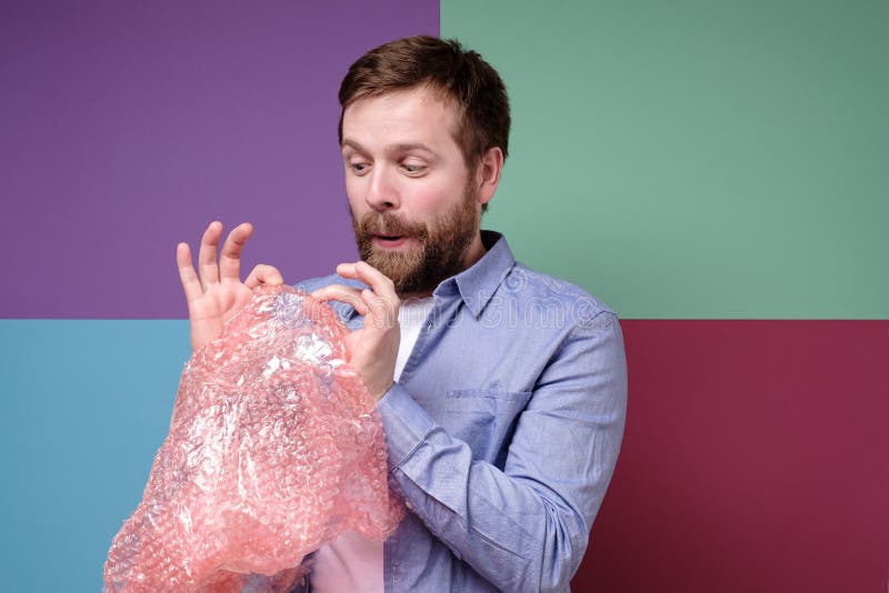 Young, Funny Man Popping a Bubble Wrap As a Therapy and Calms Down ...