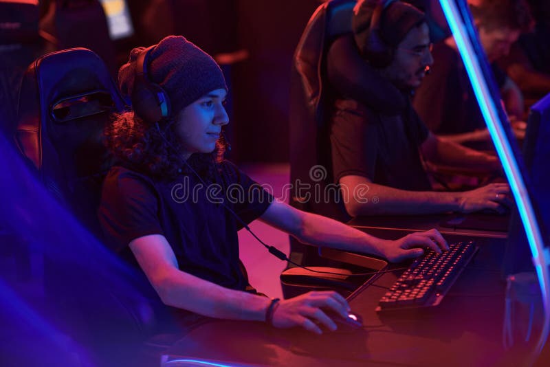 Young Gamer Interacting with Team in Online Game Stock Photo - Image of ...