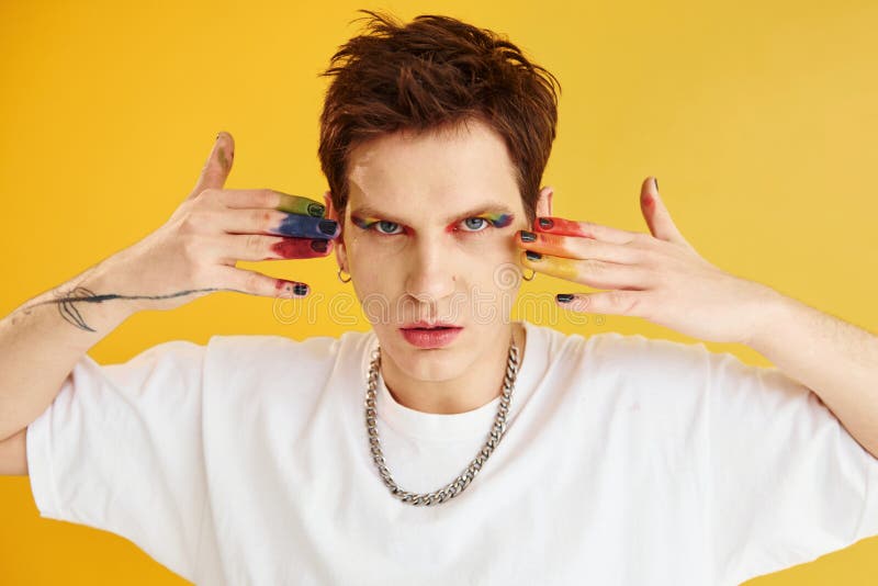 Young Gay Man is Standing in the Studio and Posing for a Camera ...