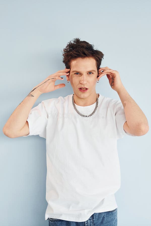 Young Gay Man is Standing in the Studio and Posing for a Camera. Red ...