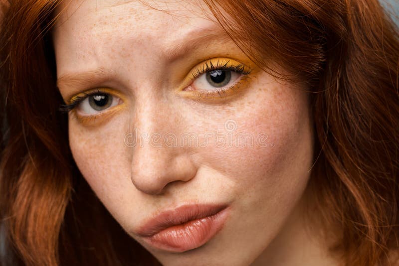 Young Ginger Confused Woman with Makeup Posing and Looking at Camera ...