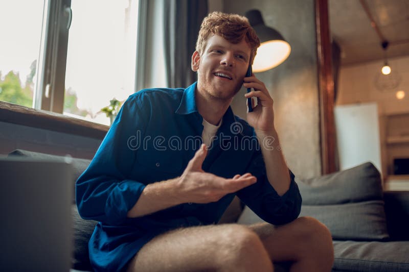A Young Ginger Man Talking on the Phone and Looking Involved Stock ...