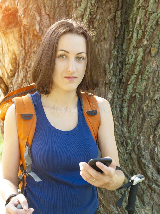 A Young Girl with a Backpack Use the Phone. Stock Image - Image of ...