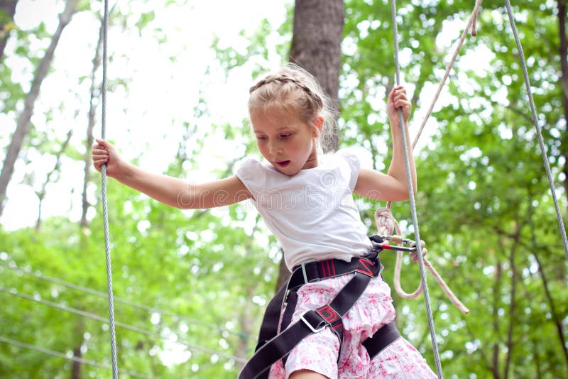 Young Girl Balancing on Rope Stock Photo - Image of beautiful, branches ...