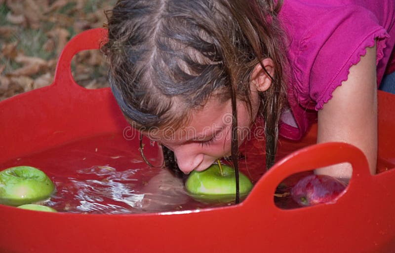 Young Girl Bobbing for Apples Stock Photo - Image of attractive ...