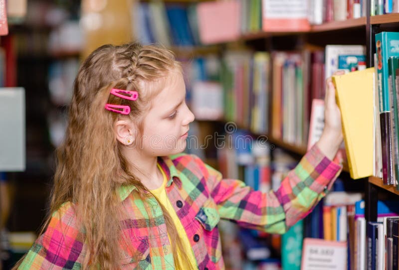 Young Girl Chooses a Book in the Library Stock Photo - Image of indoor ...